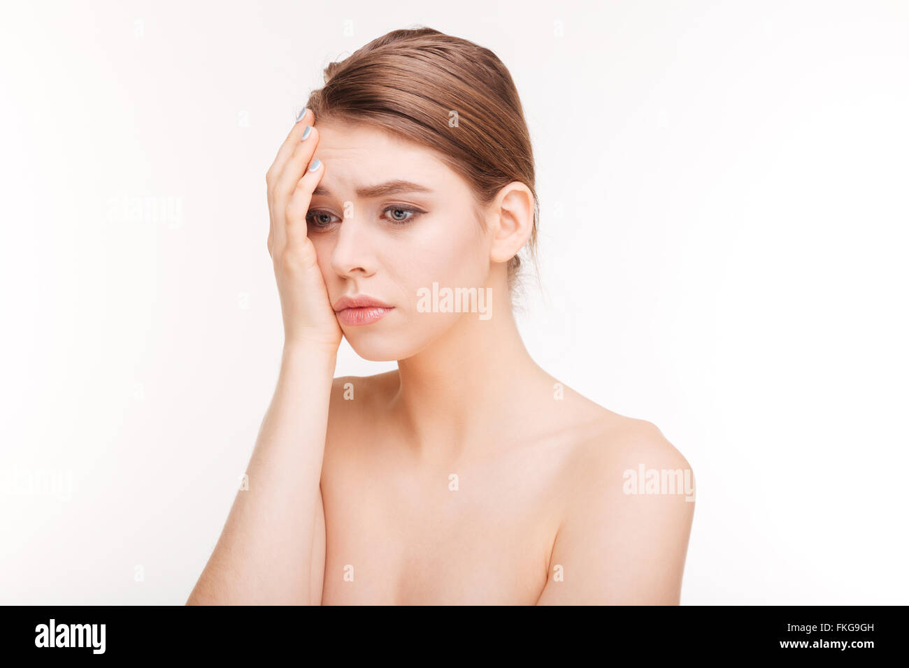 Beauty portrait of a sad woman standing isolated on a white background ...