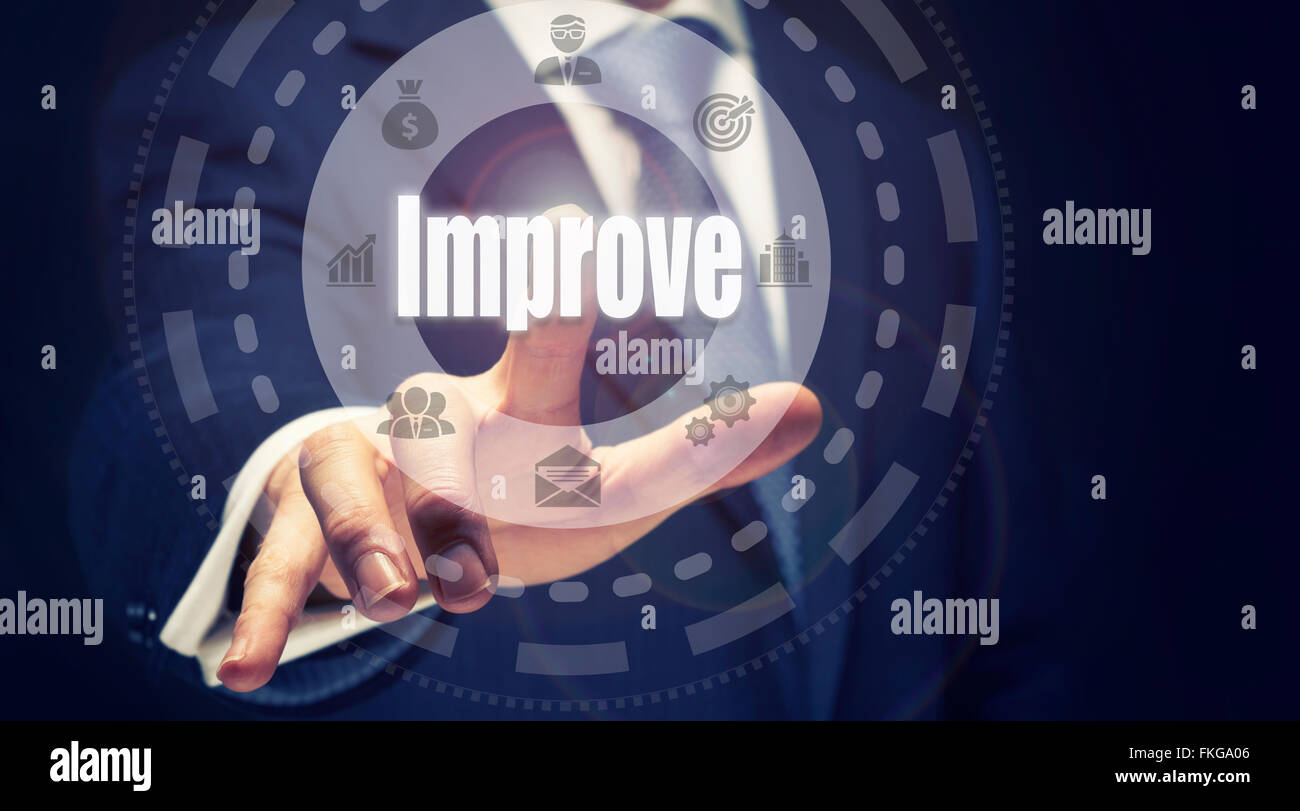 Businessman pressing an Improve concept button Stock Photo - Alamy