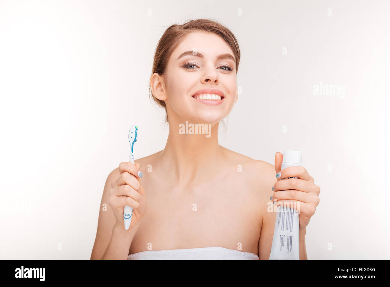 Beauty portrait of cheerful young woman with toothpaste and toothbrush ...