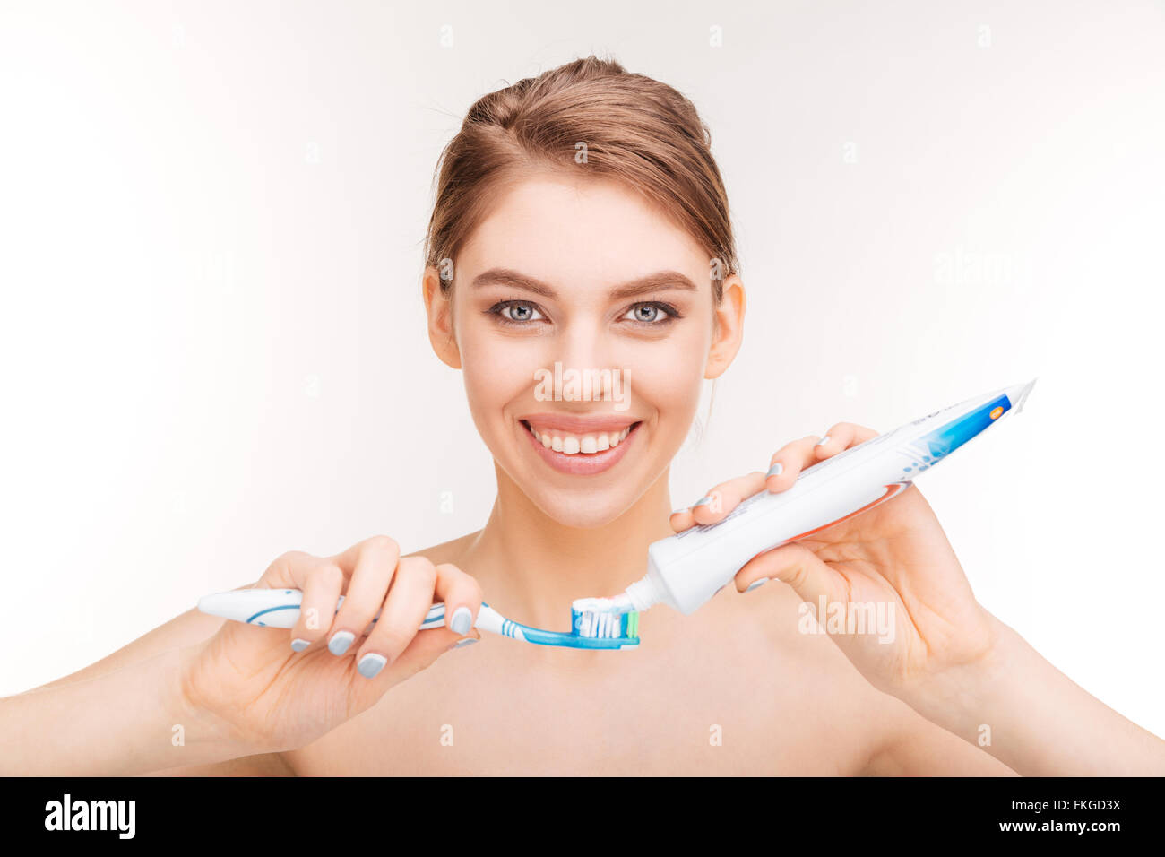 Beauty portrait of attractive smiling young woman using toothpaste and ...