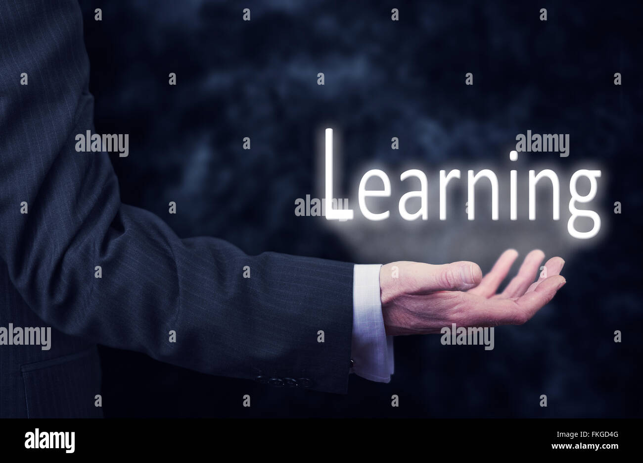 Businessman pressing an Learning concept button Stock Photo - Alamy