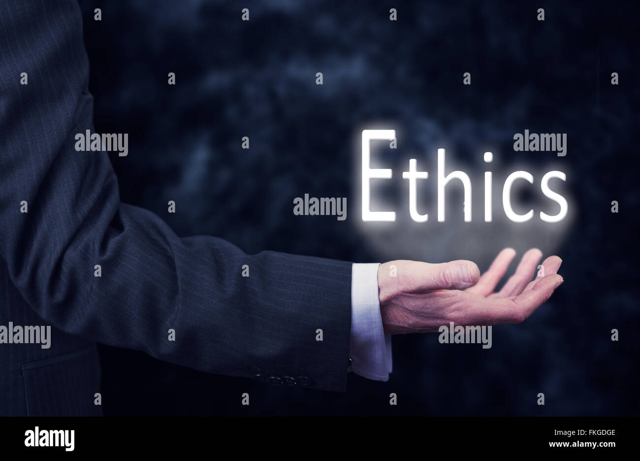 Businessman pressing an Ethics concept button Stock Photo - Alamy