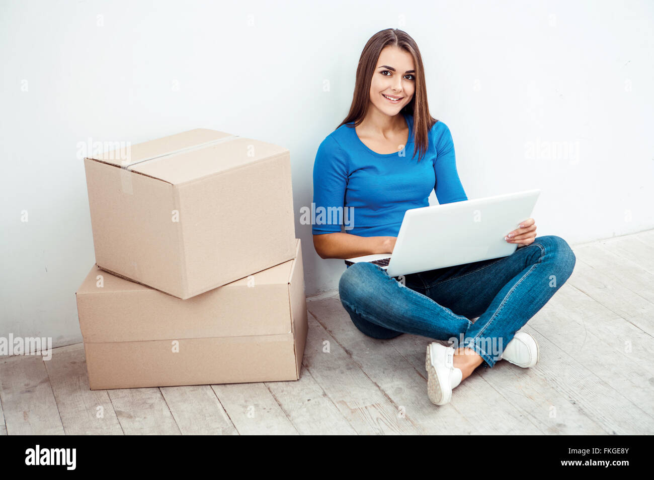 Woman moving to new home Stock Photo - Alamy