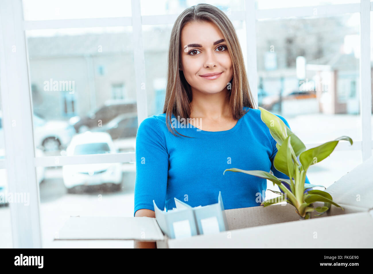 Woman moving to new home Stock Photo - Alamy