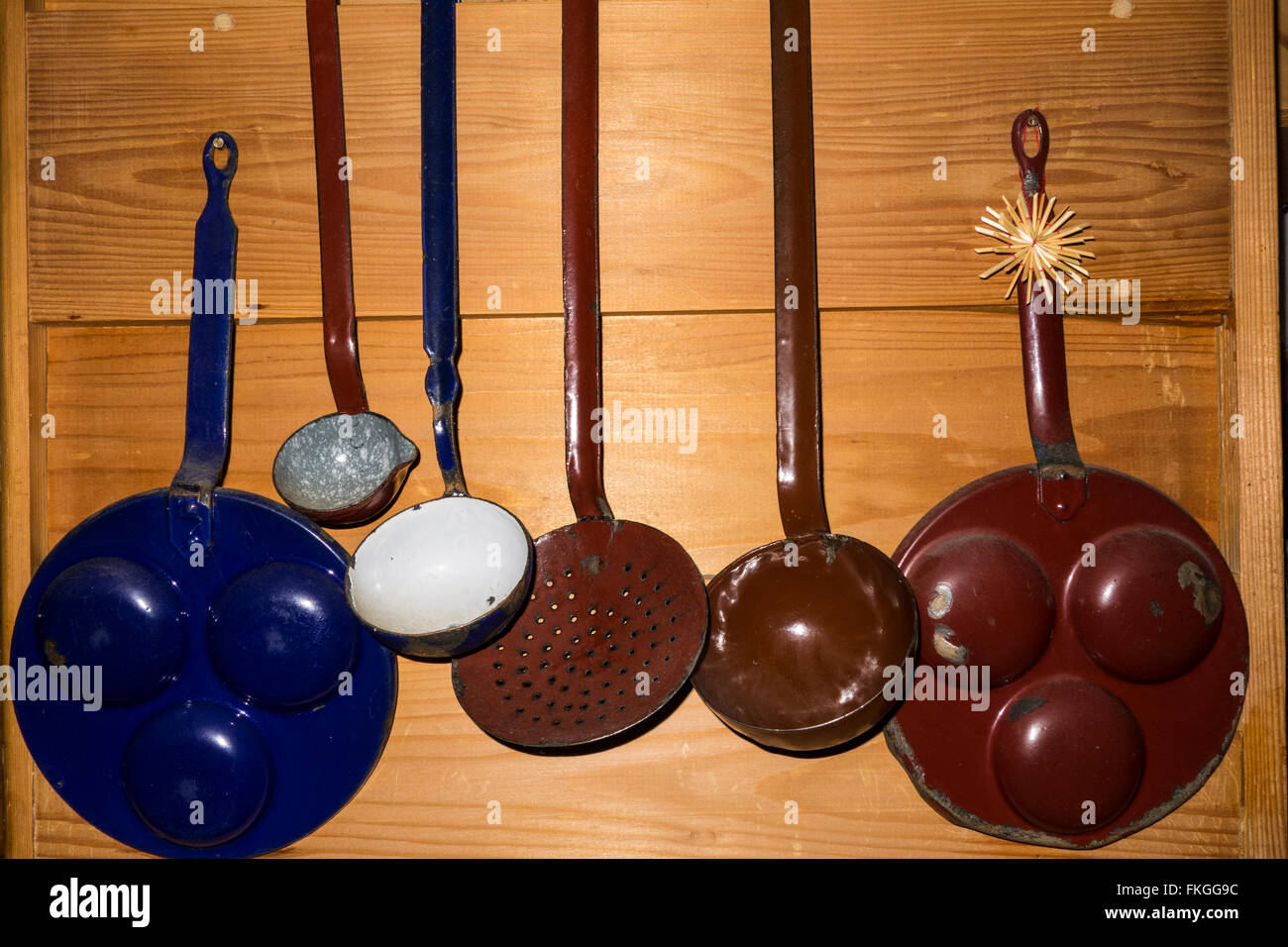Ladles and pans on a kitchen wall Stock Photo - Alamy