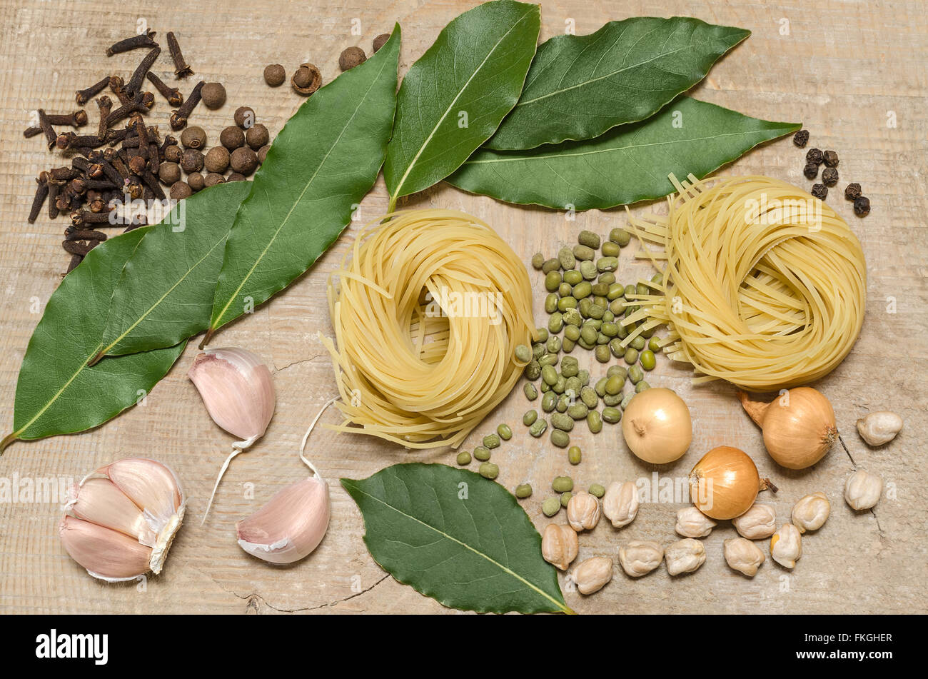 Not cooked pasta and spices lying on the old Board Stock Photo - Alamy