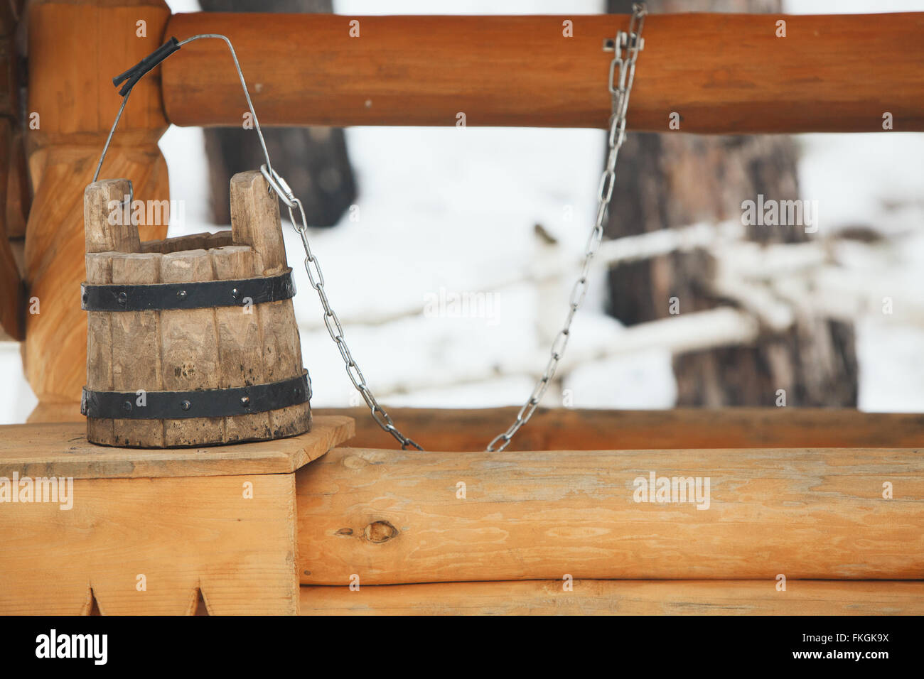 Wooden bucket standing on the well Stock Photo - Alamy