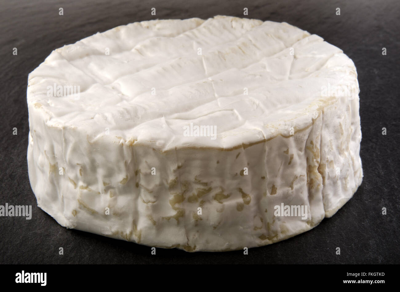 one organic whole french camembert on slate Stock Photo - Alamy