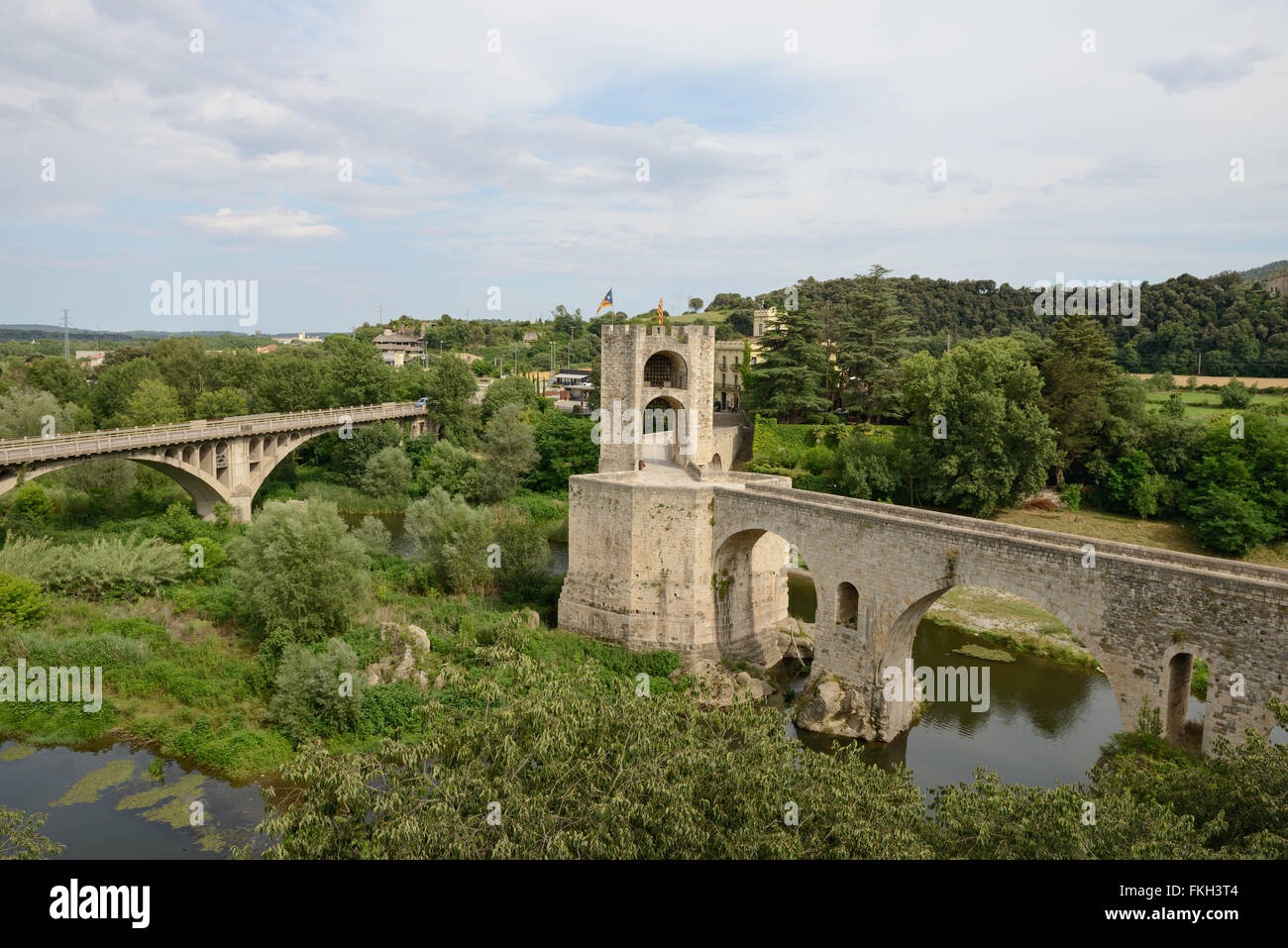 Scenic view of ancient and new bridges across Fluvia River in medieval ...