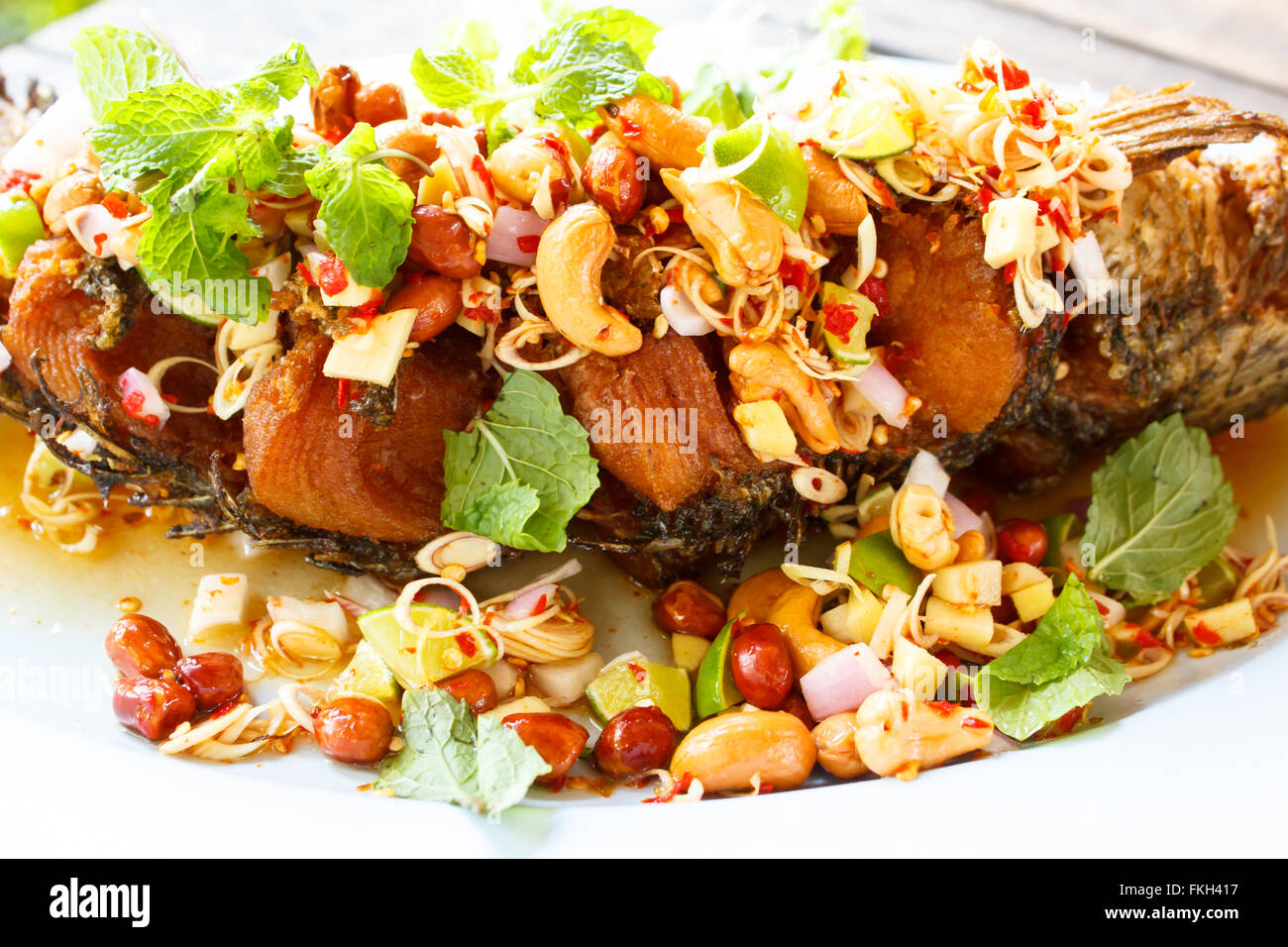 deep fried fish with herb and spicy sauce, thai food Stock Photo - Alamy