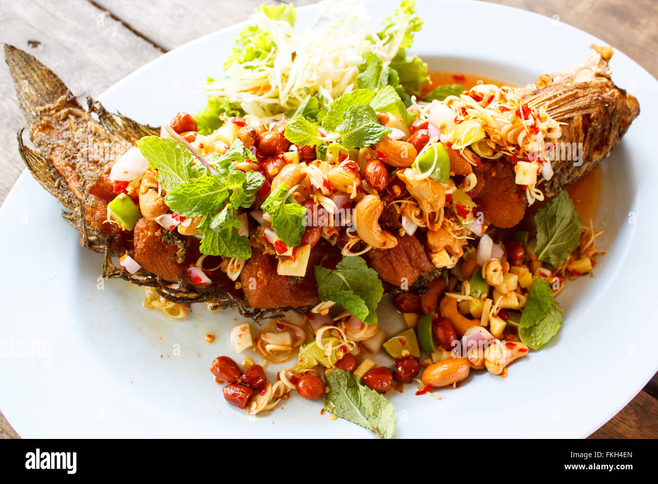 deep fried fish with herb and spicy sauce, thai food Stock Photo - Alamy