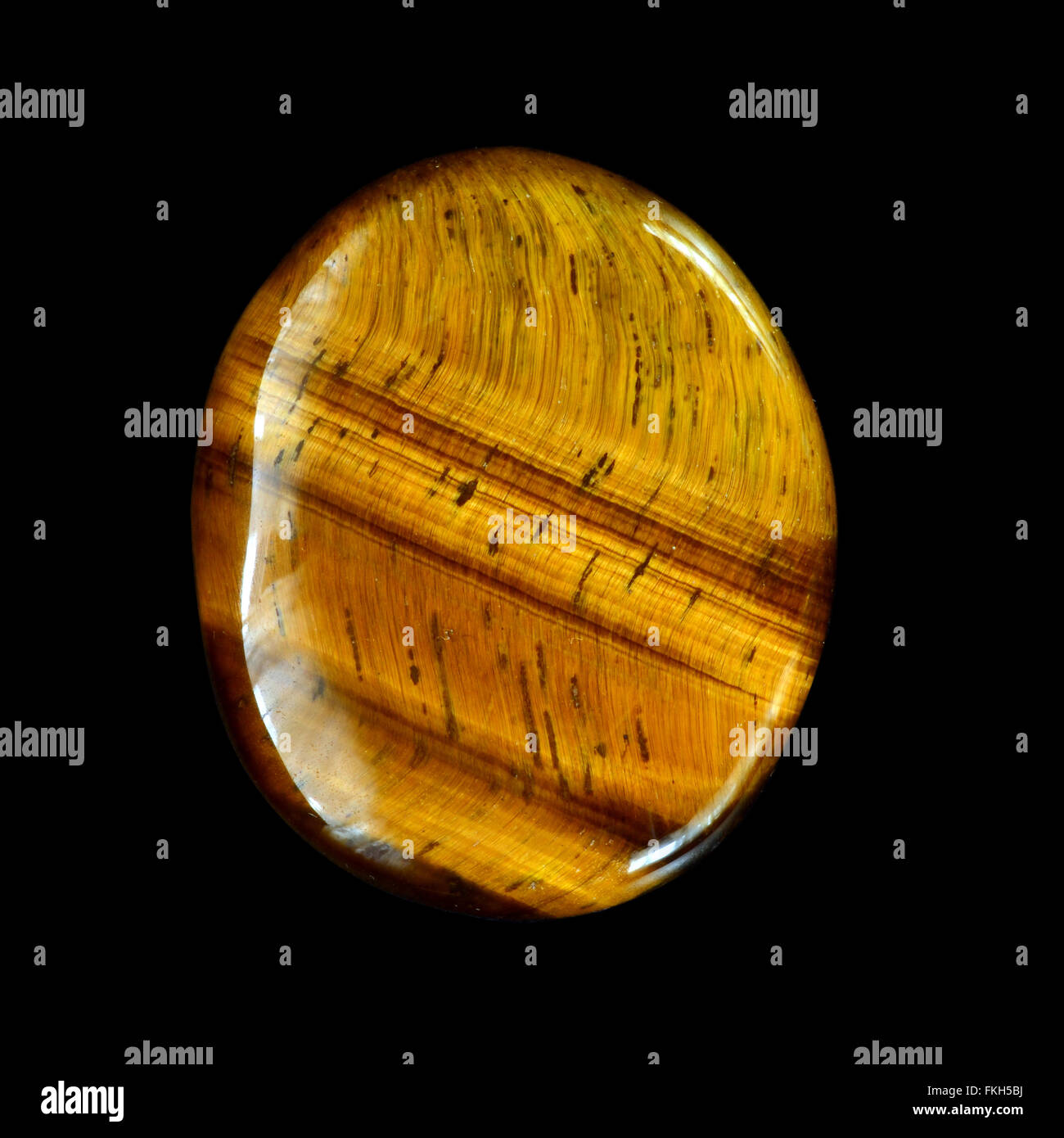 Tiger eye gemstone isolated on black background Stock Photo - Alamy