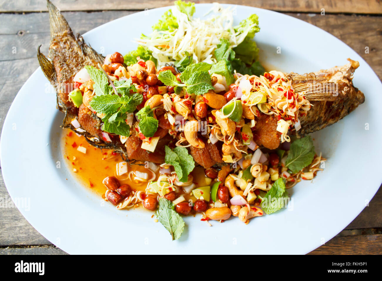 deep fried fish with herb and spicy sauce, thai food Stock Photo - Alamy