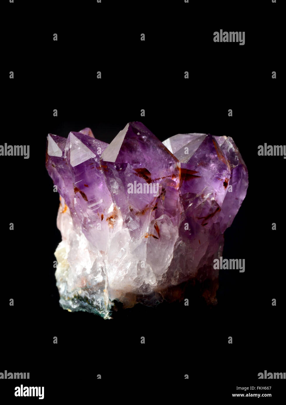 Raw amethyst brazilian rock, on a black background Stock Photo - Alamy