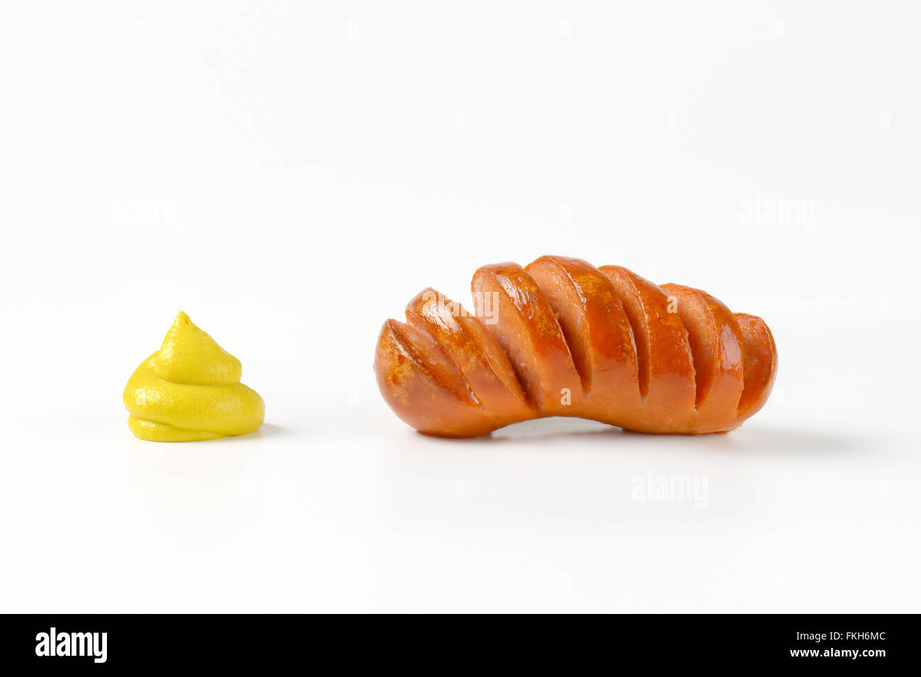 roasted sausage and mustard swirl on white background Stock Photo - Alamy