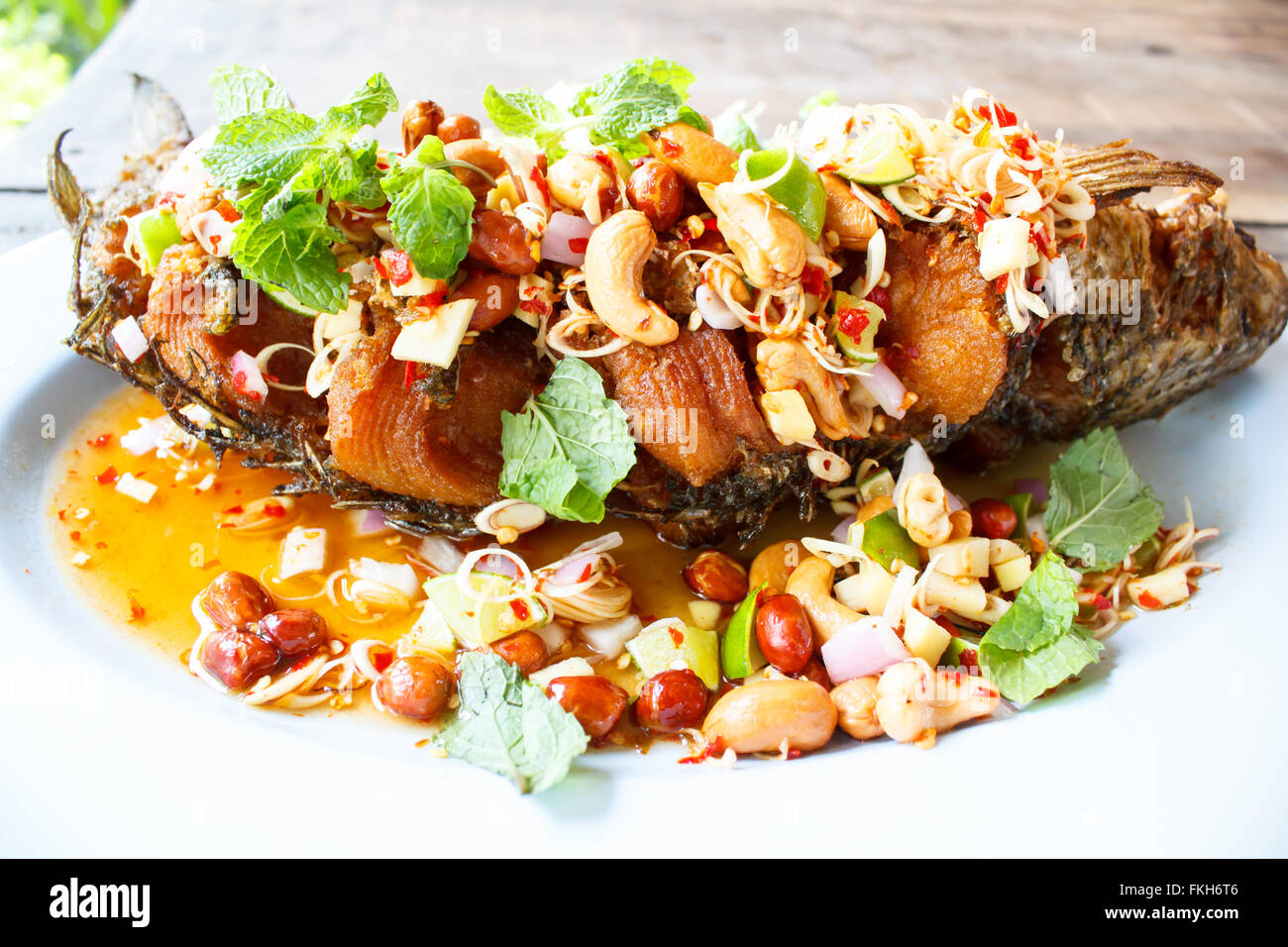 deep fried fish with herb and spicy sauce, thai food Stock Photo - Alamy