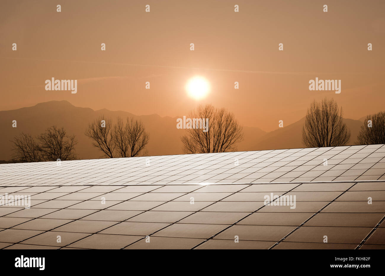 Setting sun and solar panels Stock Photo - Alamy