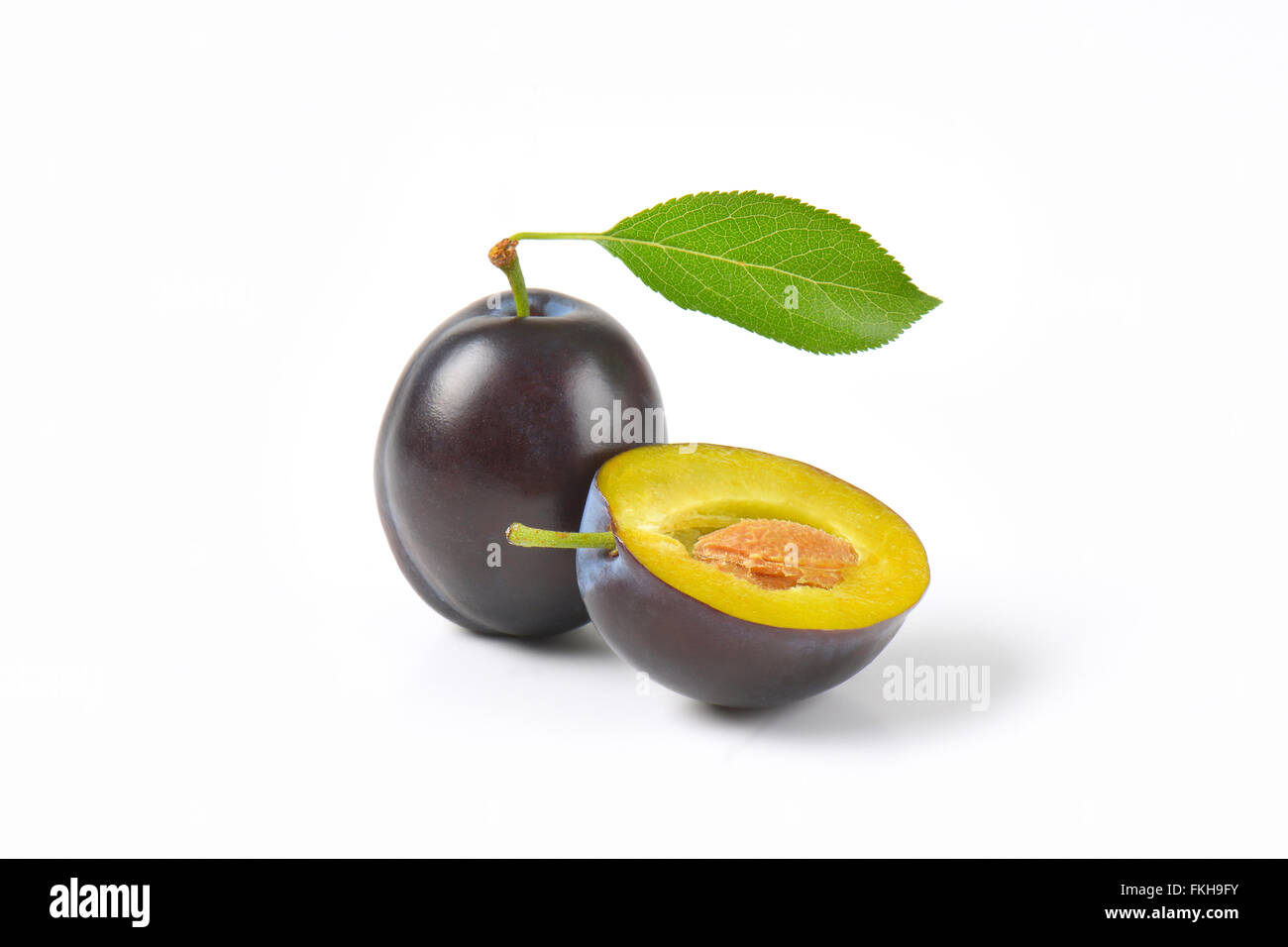 Whole half ripe plums Cut Out Stock Images & Pictures - Alamy