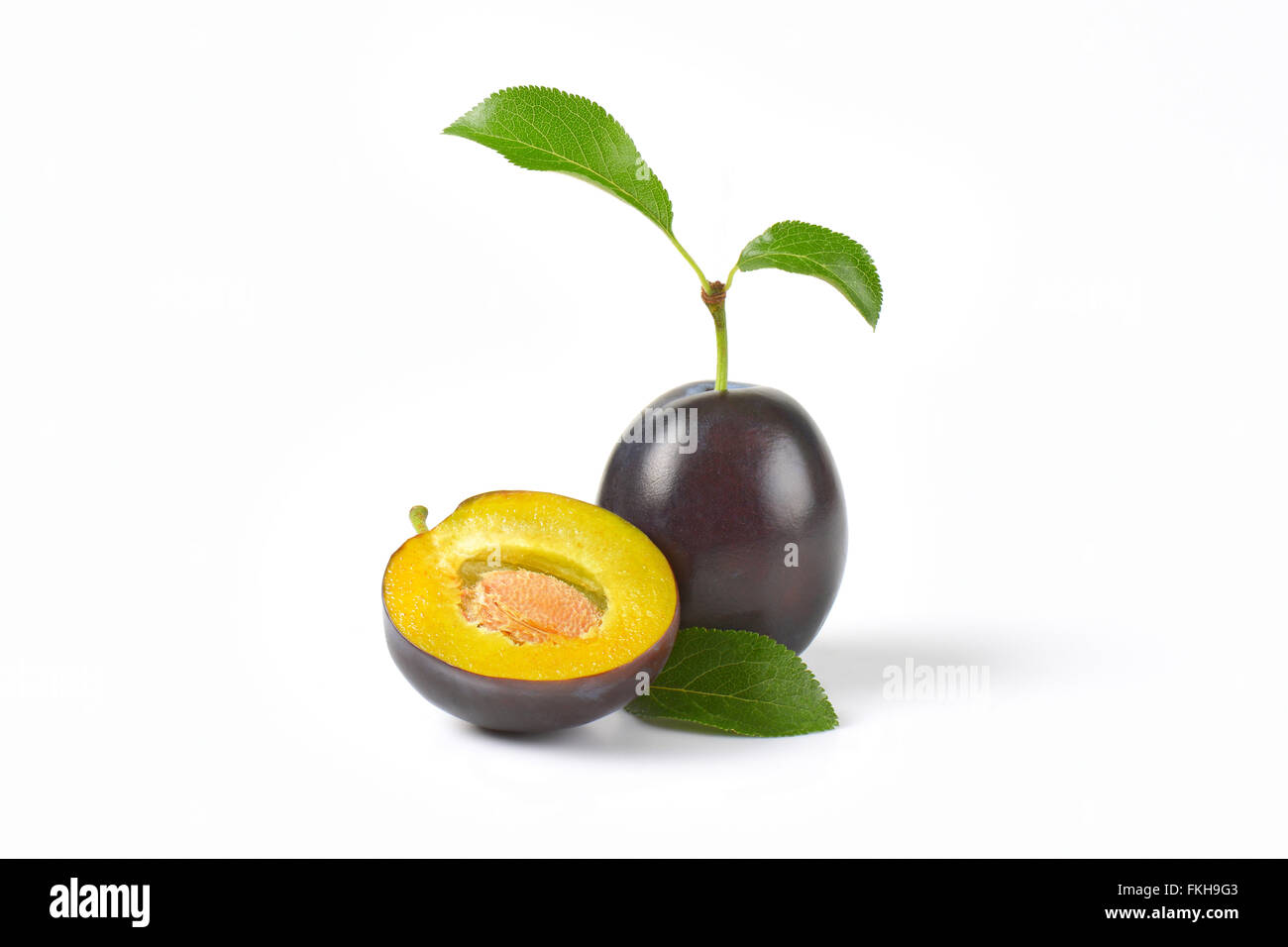 Whole half ripe plums Cut Out Stock Images & Pictures - Alamy