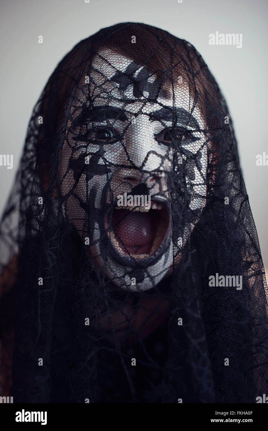 Portrait of a spooky girl screaming behind the veil Stock Photo - Alamy