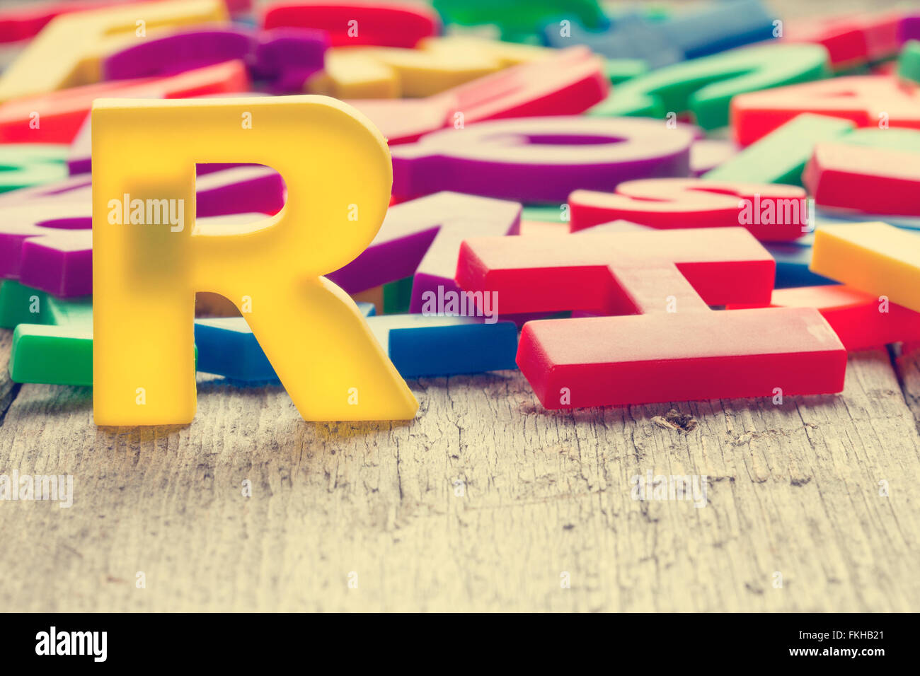 Capital letter R in a front of other colorful plastic letters. Vintage ...