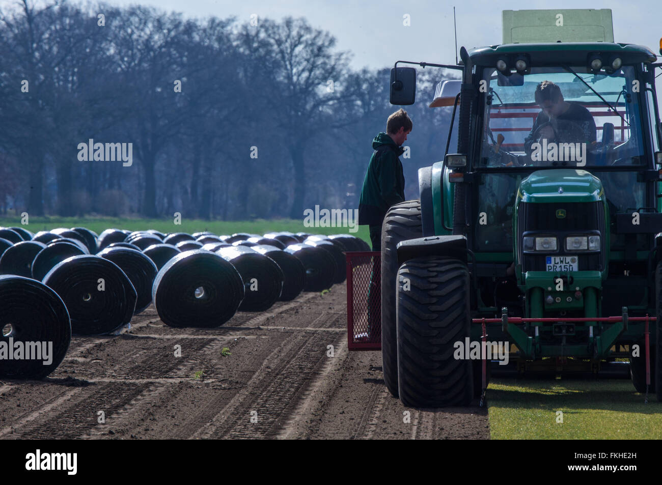Staff members operate a special machine that peels and rolls up metres ...