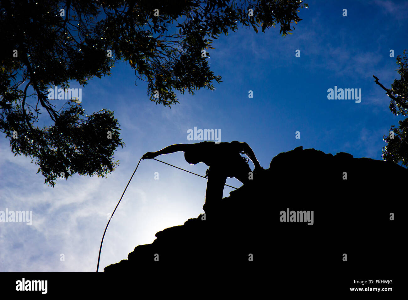 Rappelling down of a cliff after rock climbing up Stock Photo - Alamy