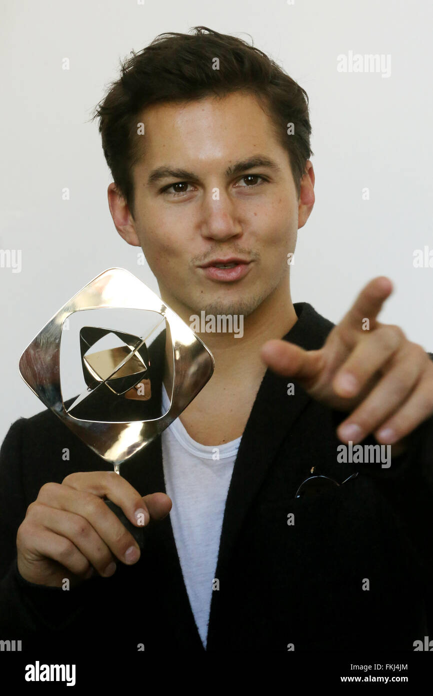 Essen, Germany. 09th Mar, 2016. Actor Tom Oliver Schultz holds up the ...