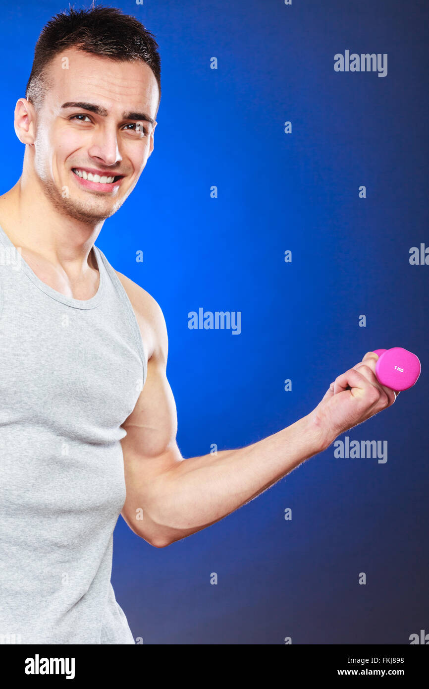 Funny sporty fit man lifting light dumbbell weight. Young muscular ...