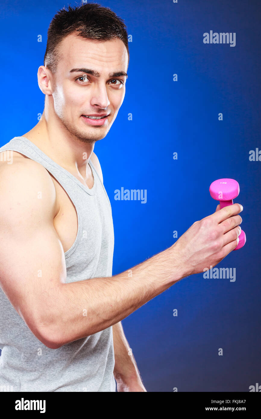 Funny sporty fit man lifting light dumbbell weight. Young muscular ...