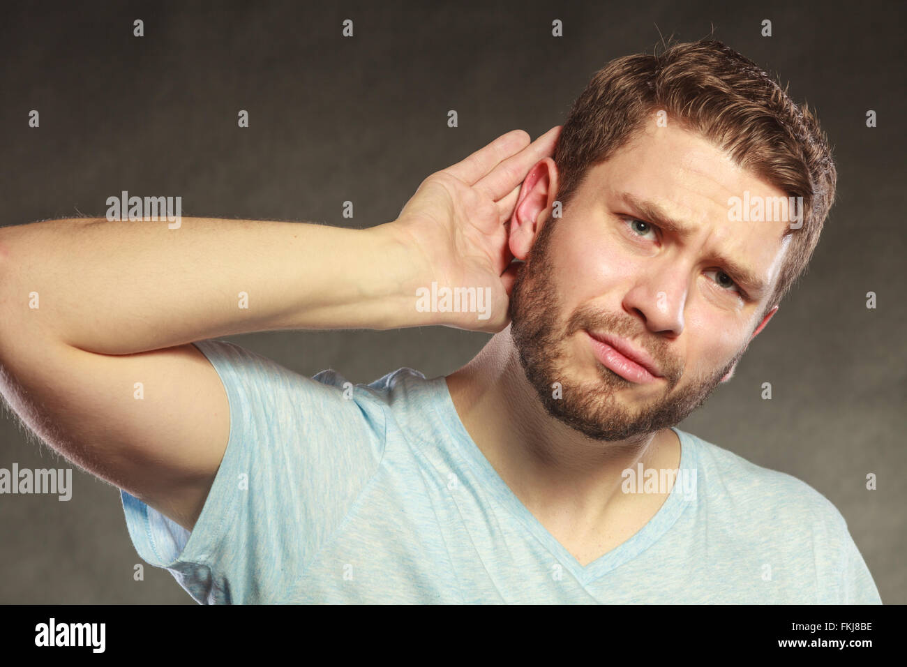 Gossip man eavesdropping with hand to ear. Guy overhearing listening to ...