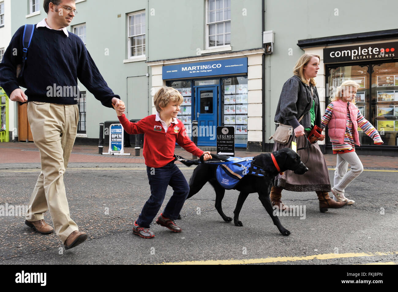 Guide dog for Autistic Son Marcus is connected to Ivan via a strap and ...