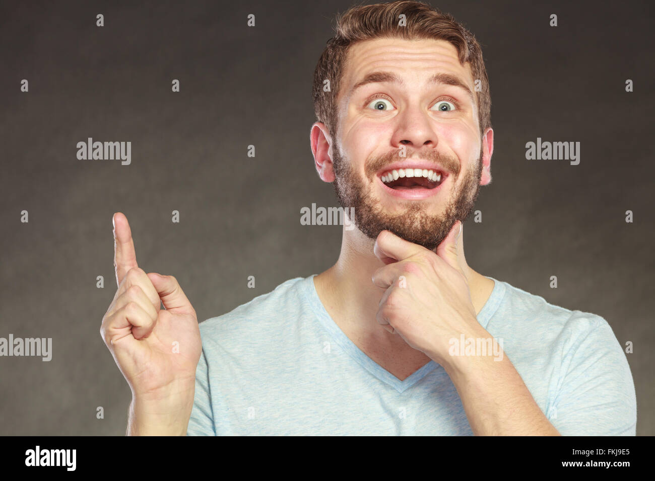 Portrait of surprised scared handsome man pointing at empty blank copy ...
