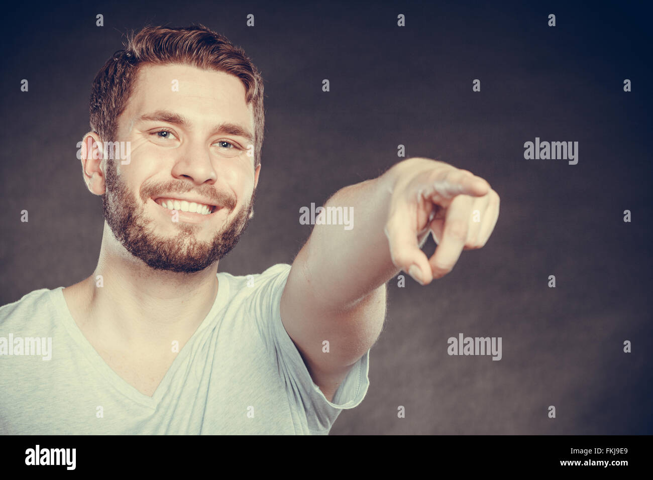 Portrait of handsome man pointing at empty blank copy space. Young guy ...