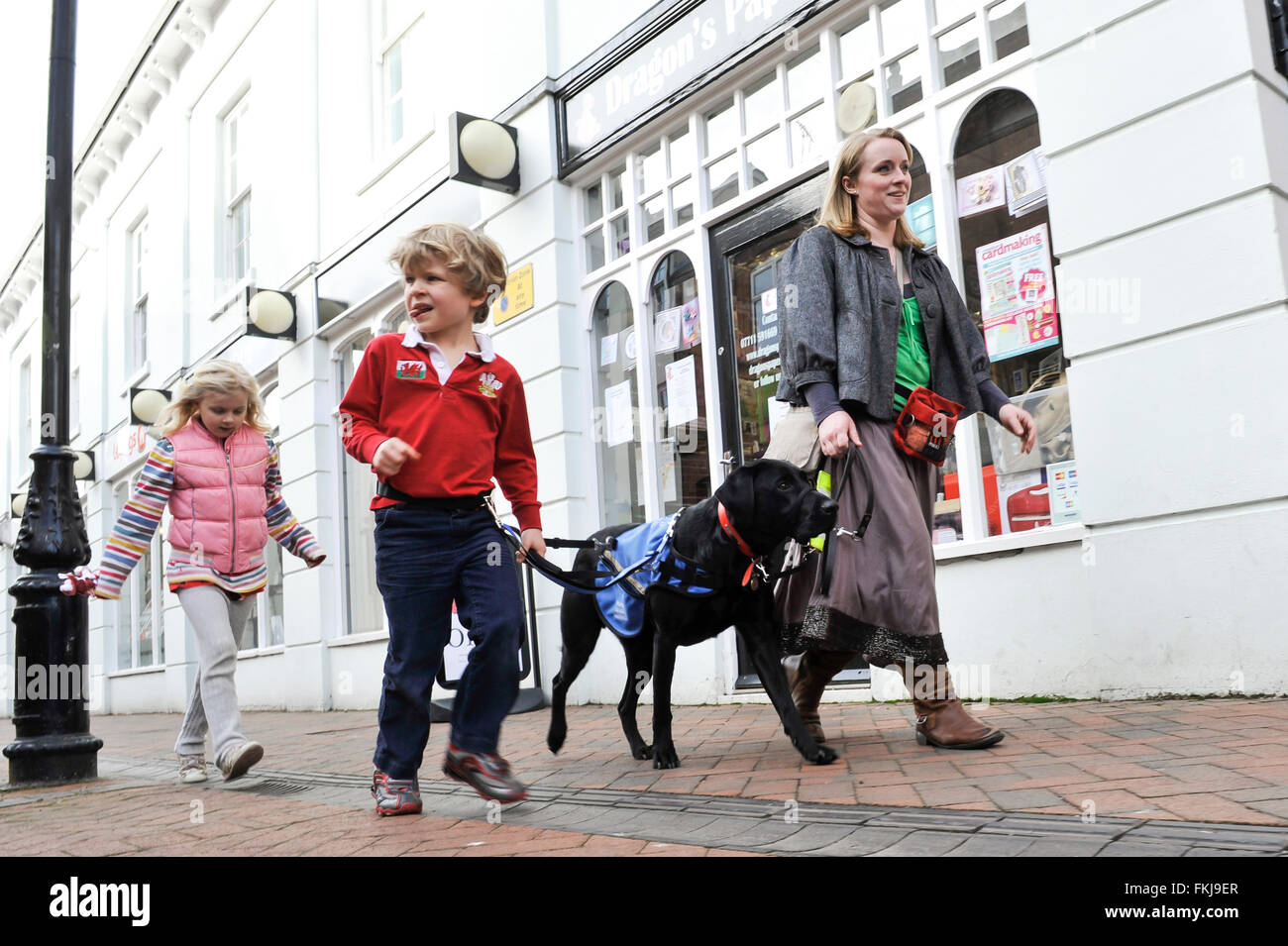 Guide dog for Autistic Son Marcus is connected to Ivan via a strap and ...