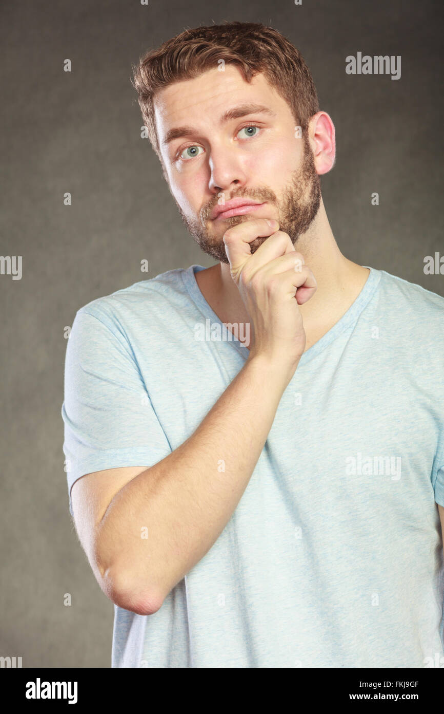 Portrait of pensive thoughtful handsome man in shirt. Young guy ...