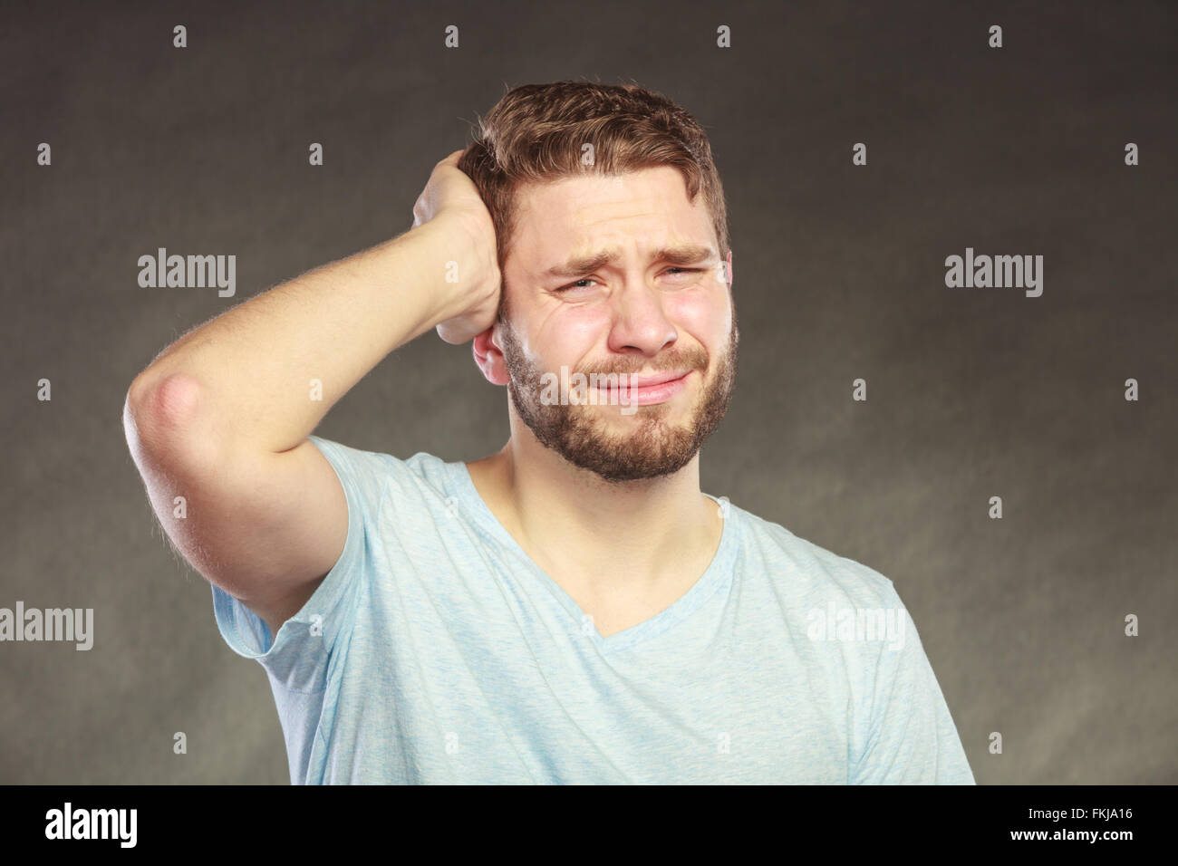 Portrait of sad depressed handsome man in shirt crying. Young guy ...