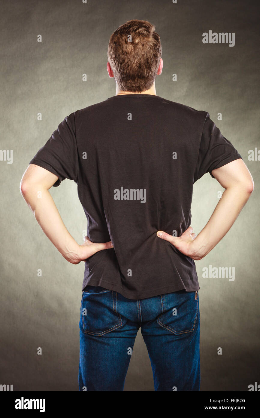 Back rear view of fashionable man in black blank shirt with empty copy ...