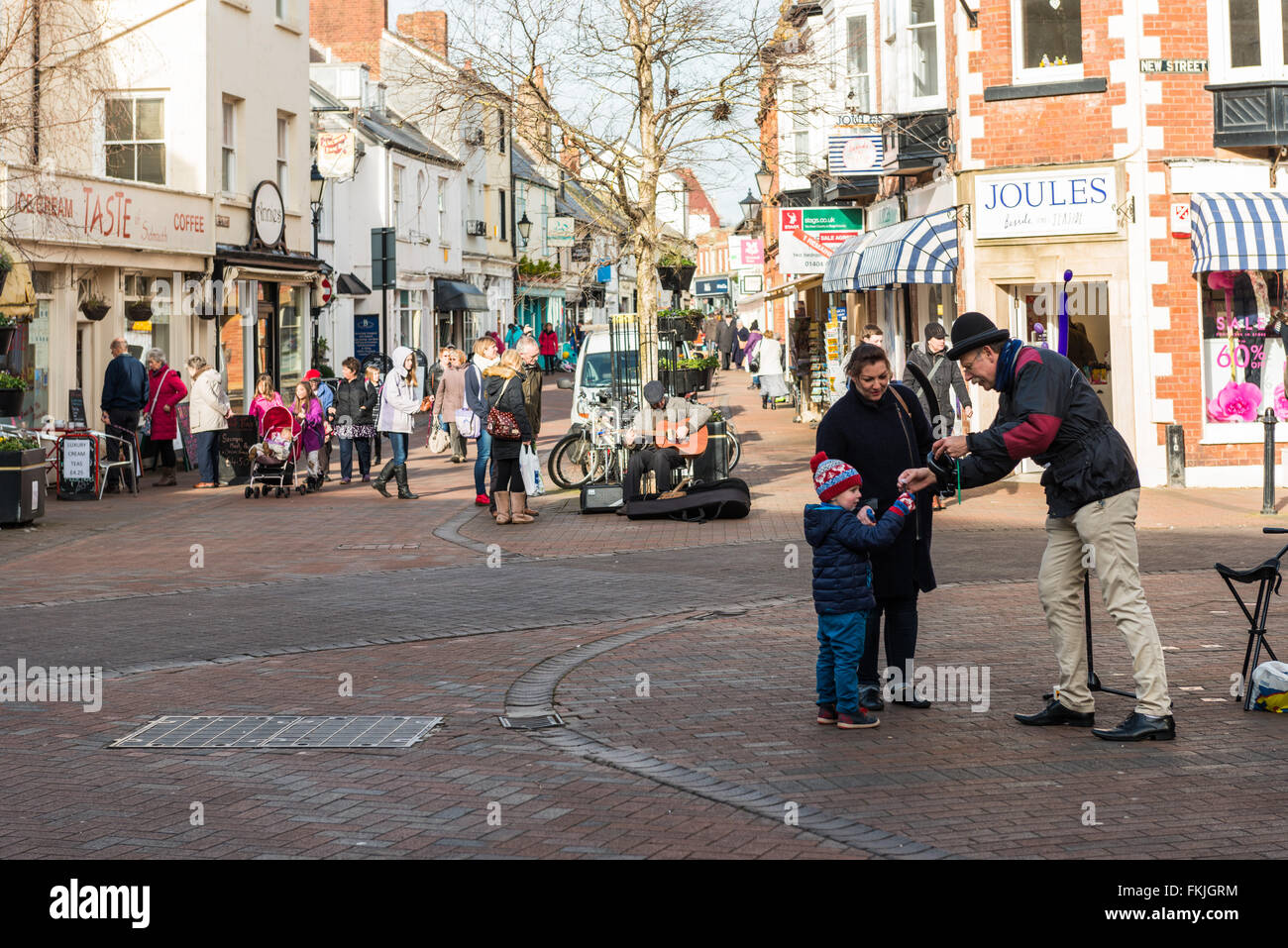 A street balloon seller takes money from a child for a balloon in ...
