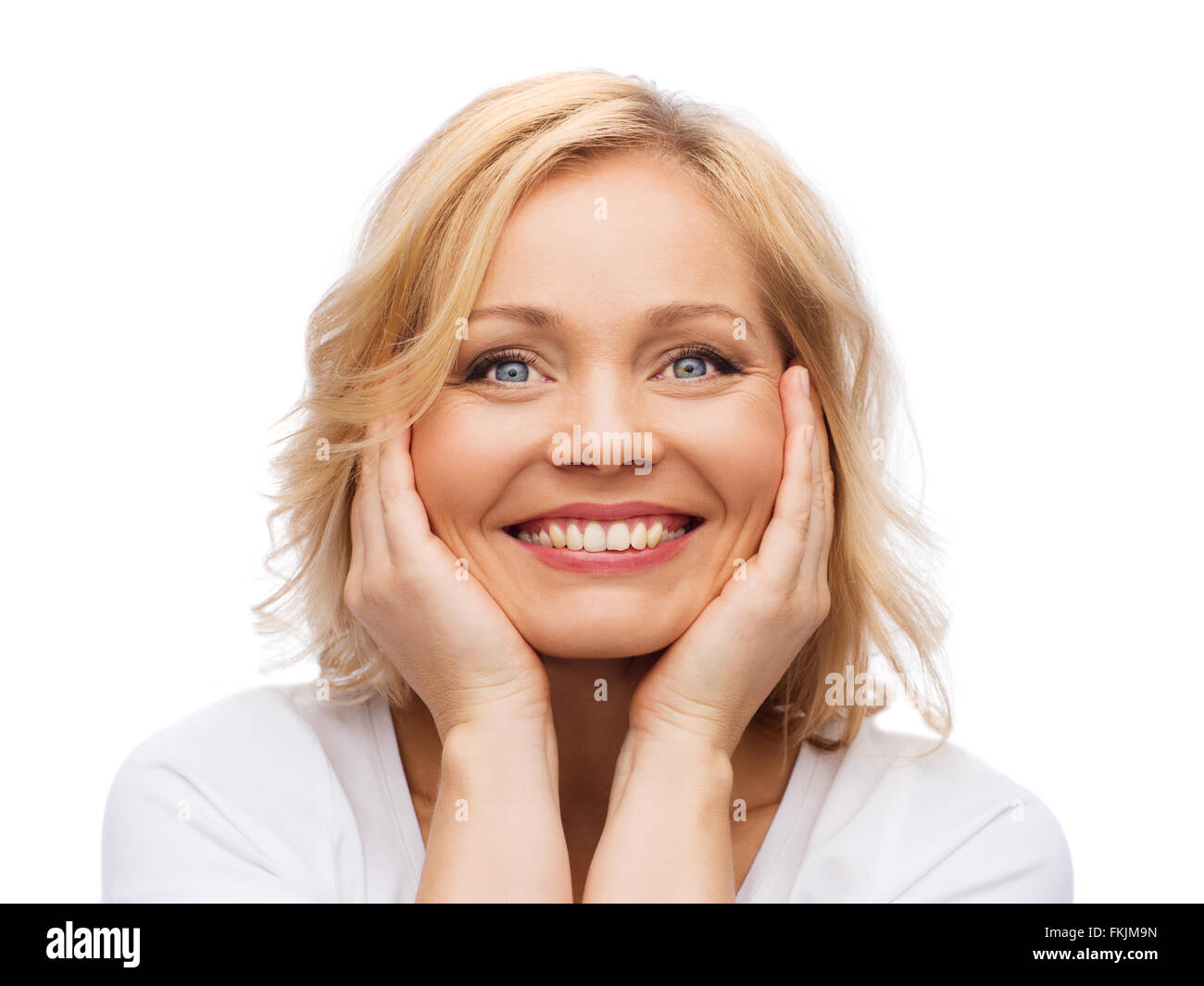 smiling woman in white t-shirt touching her face Stock Photo - Alamy