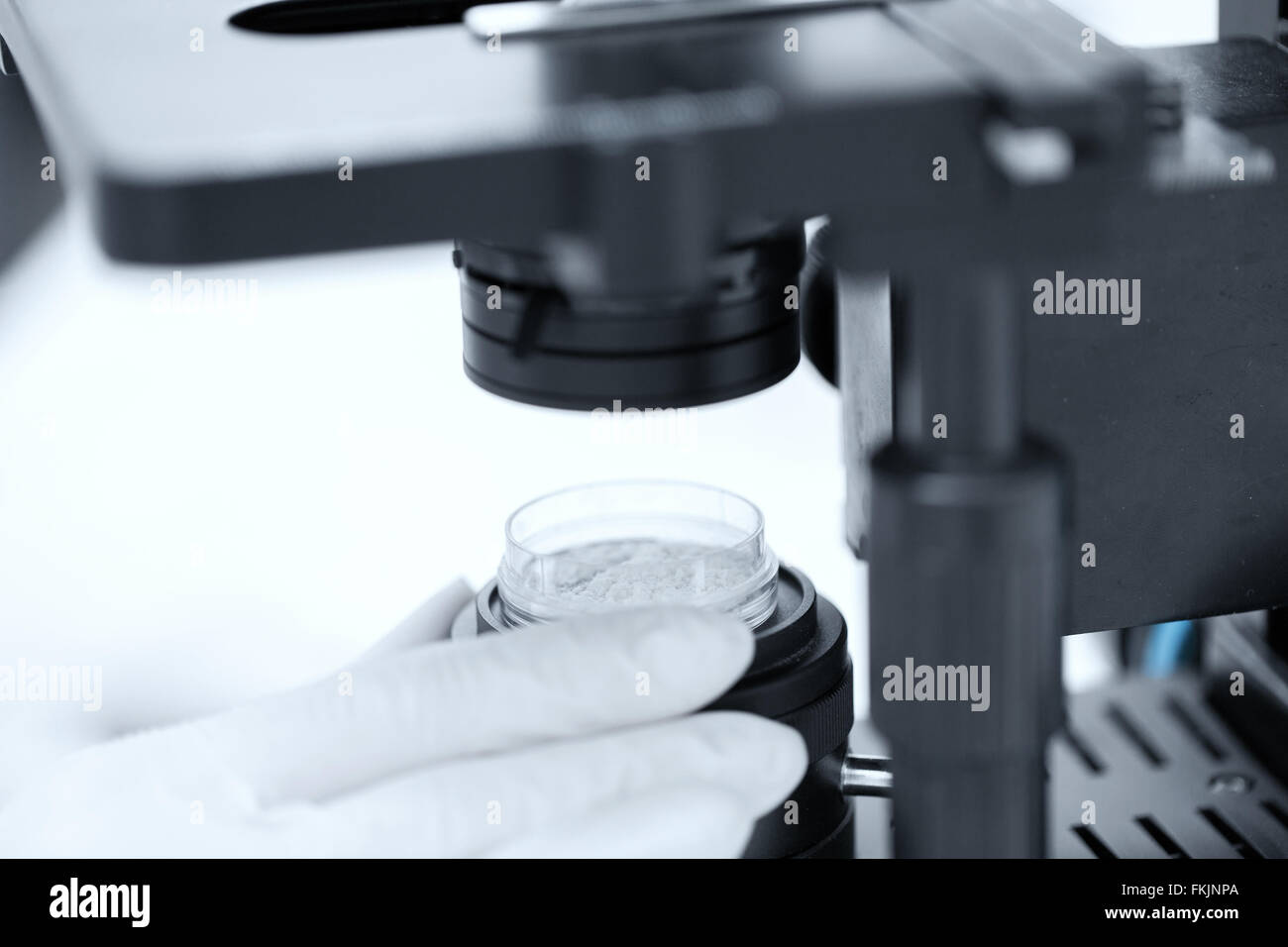 close up of hand with microscope and powder sample Stock Photo - Alamy
