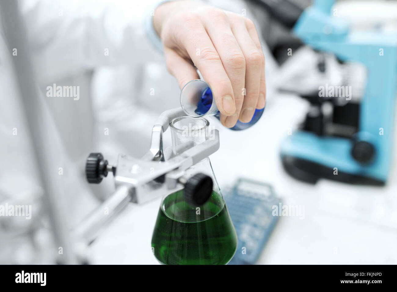 close up of scientist filling test tubes in lab Stock Photo - Alamy