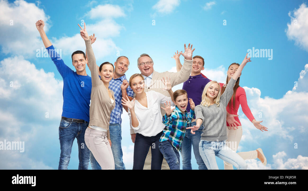 happy people having fun over sky and clouds Stock Photo - Alamy