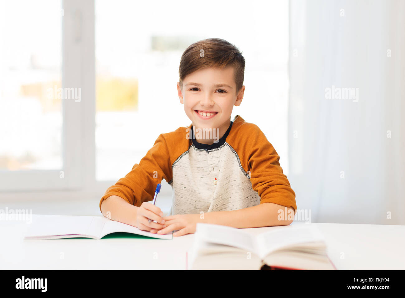 Teen boy writing classroom hi-res stock photography and images - Alamy