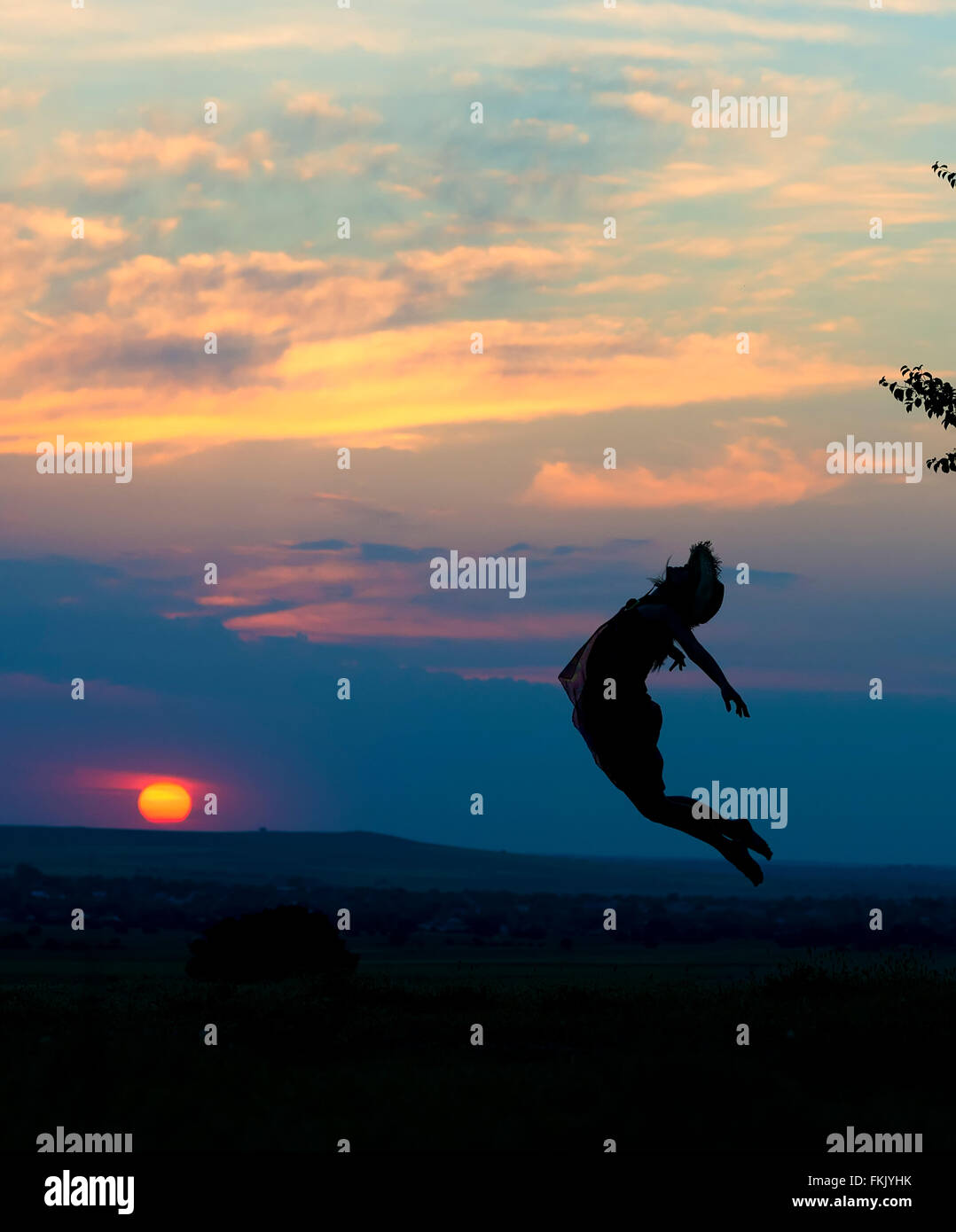 silhouette of a beautiful girl jumping in the sunset Stock Photo - Alamy