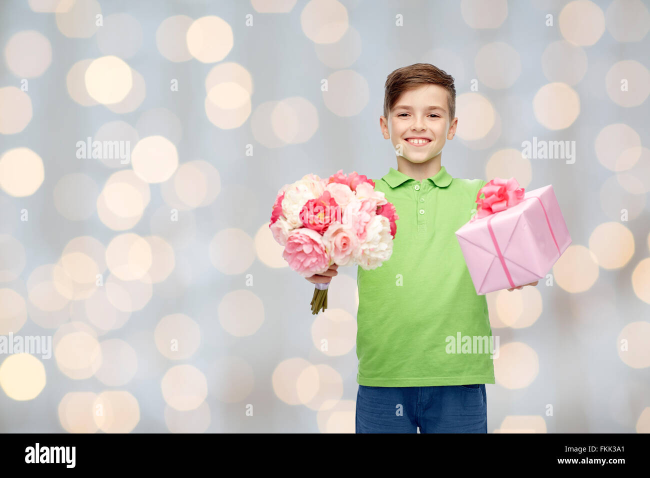 happy boy holding flower bunch and gift box Stock Photo - Alamy