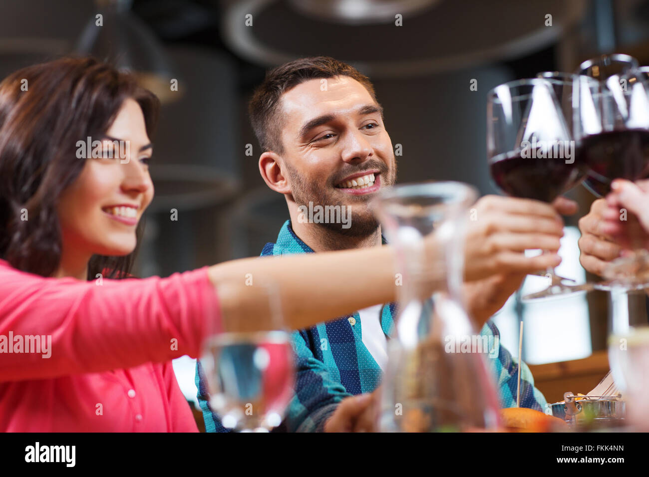 friends clinking glasses of wine at restaurant Stock Photo - Alamy