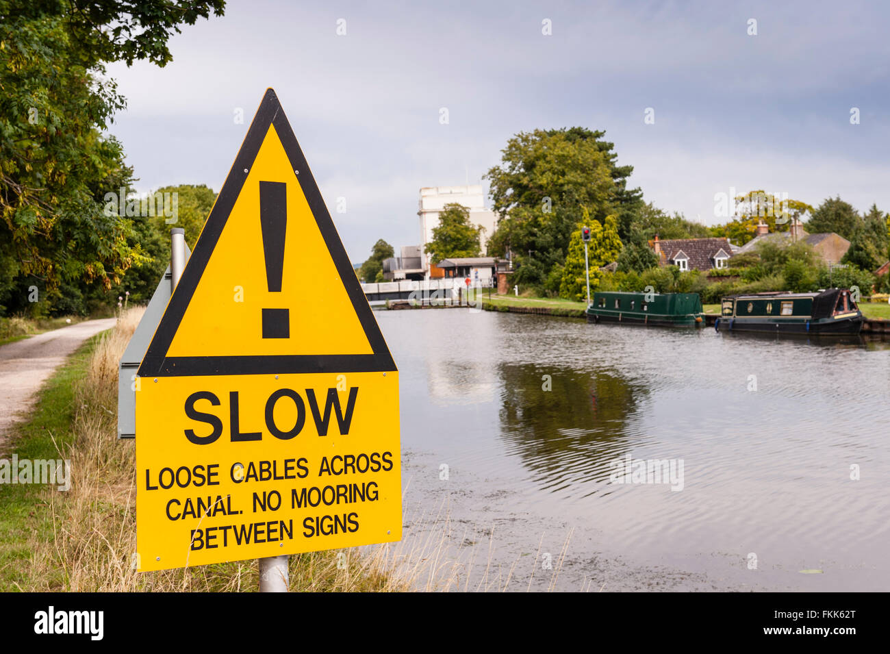 A warning sign says no mooring between signs on the canal in Frampton ...