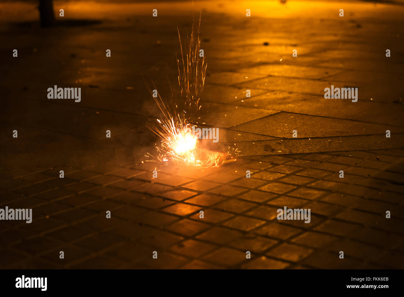 Explosion of a firecracker on the street at night in Barcelona ...