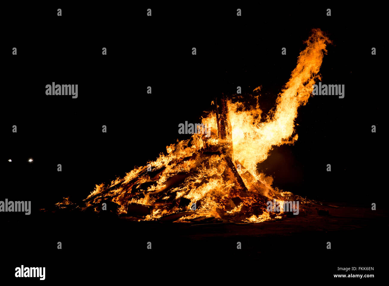 Bonfire at night on a street with a car driving Stock Photo - Alamy